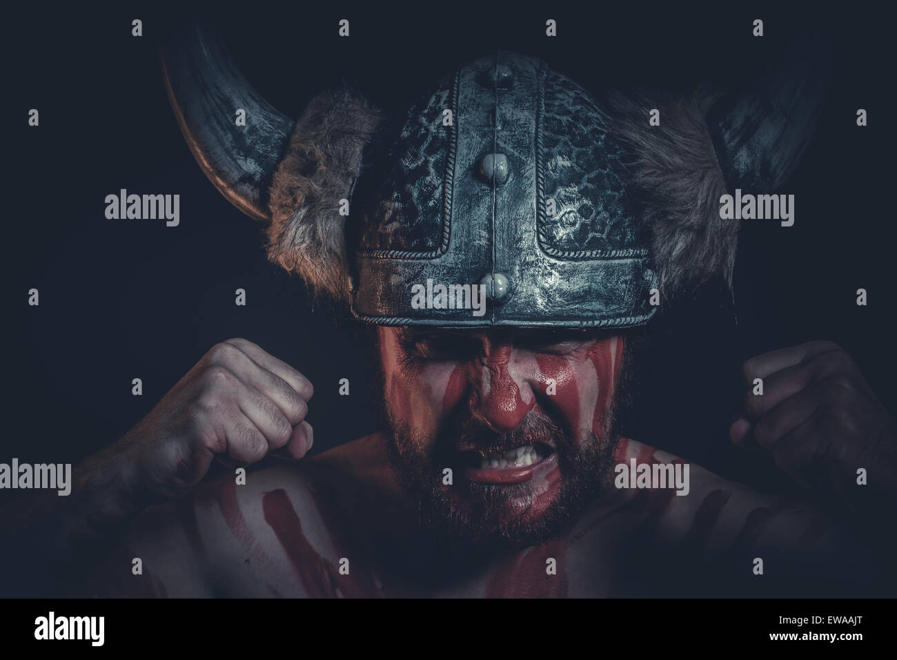 Aggression, Viking warrior with a horned helmet and war paint on his ...