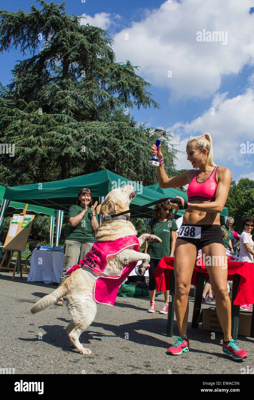 Athletic blonde girl running with her dog Stock Photo - Alamy