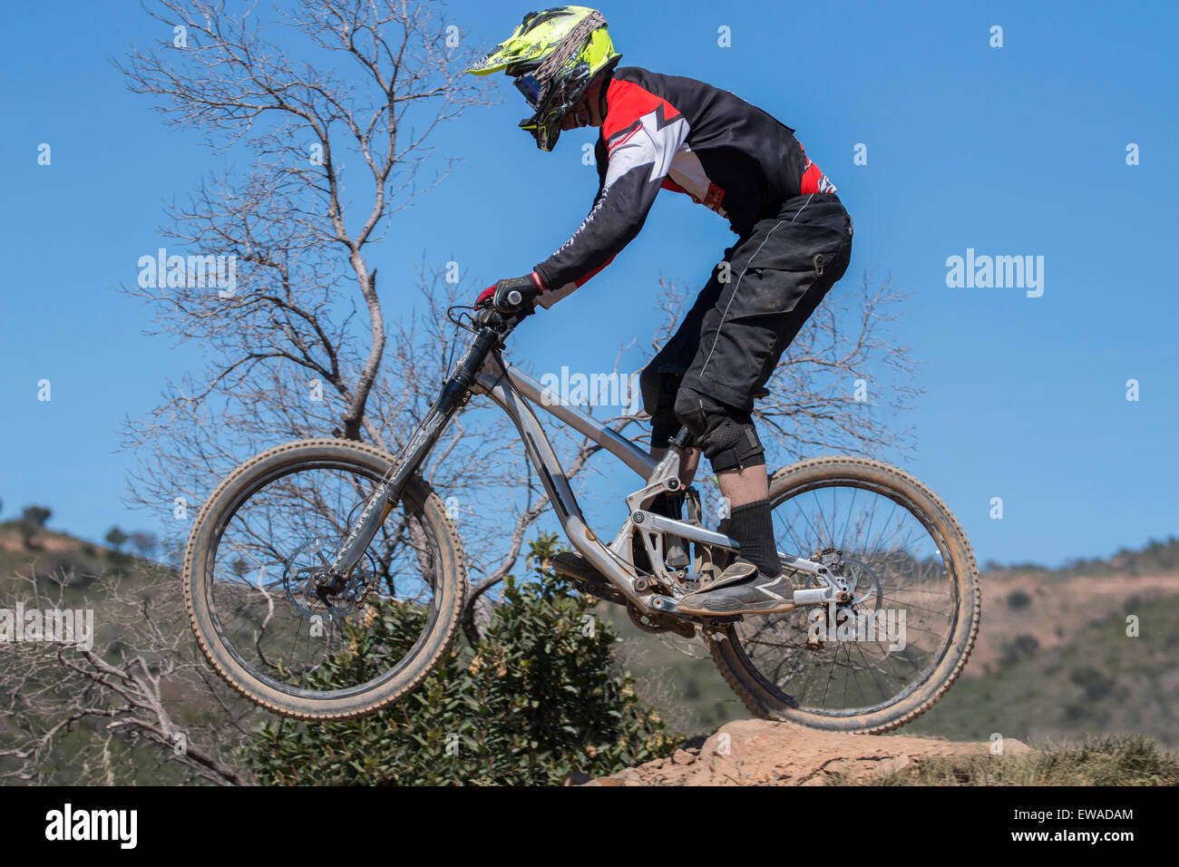 Downhill competition, Biker jumps fast in the countryside Stock Photo ...