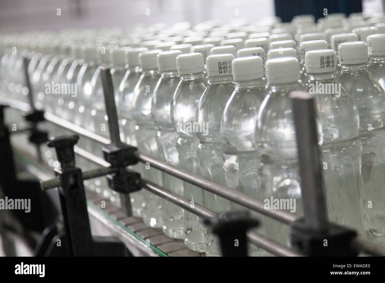 Bottle filled with water standing on the assembly line Stock Photo - Alamy