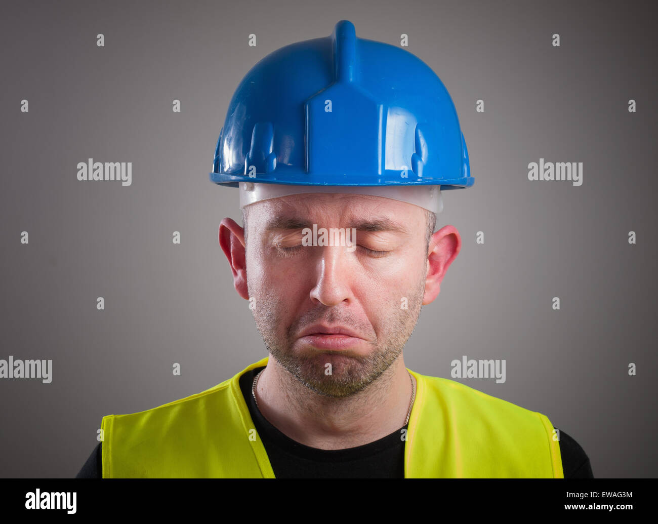 Portrait of a worker expressing negativity and sad, isolated on dark ...