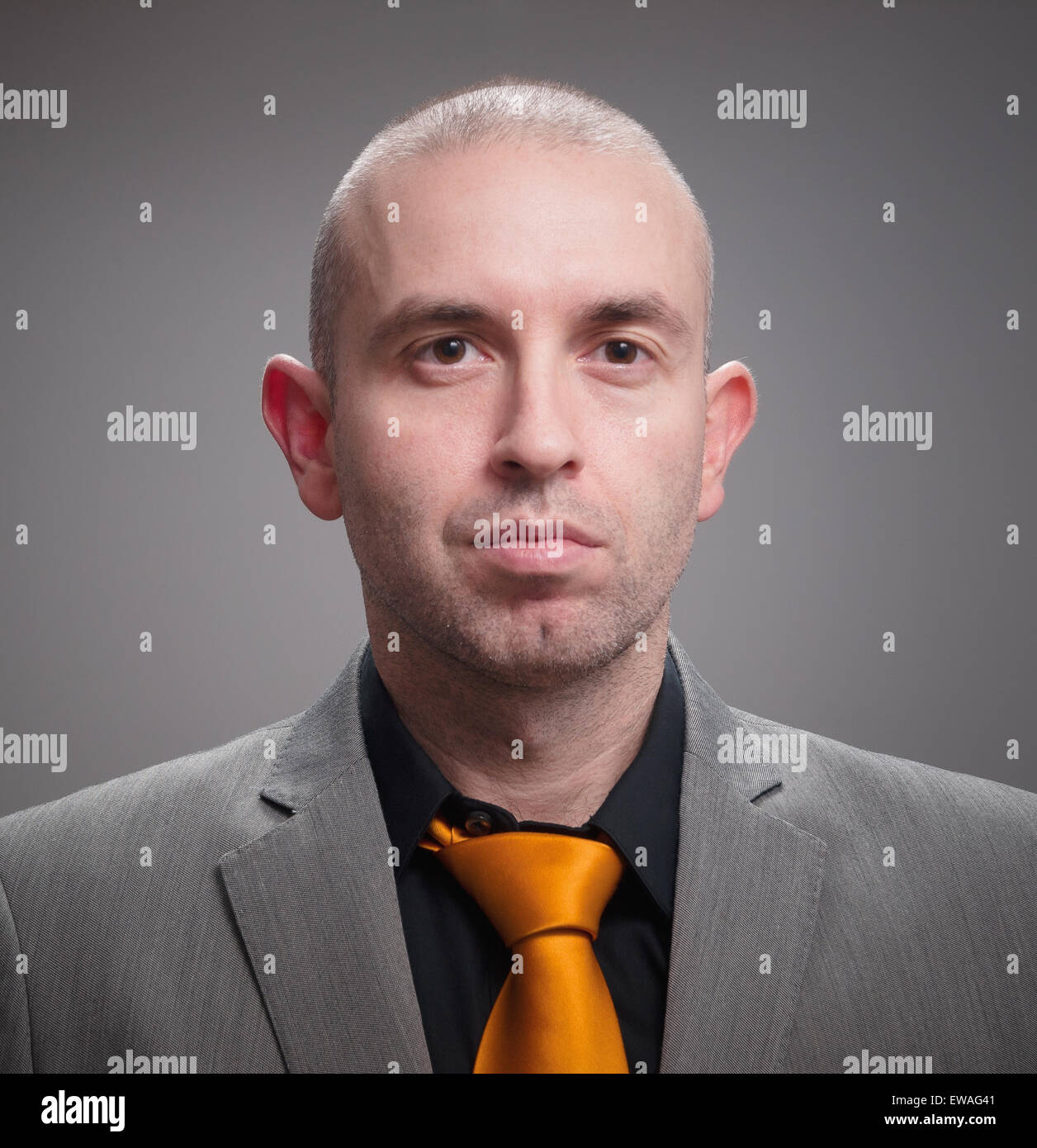 Businessman portrait in square composition and isolated on dark ...