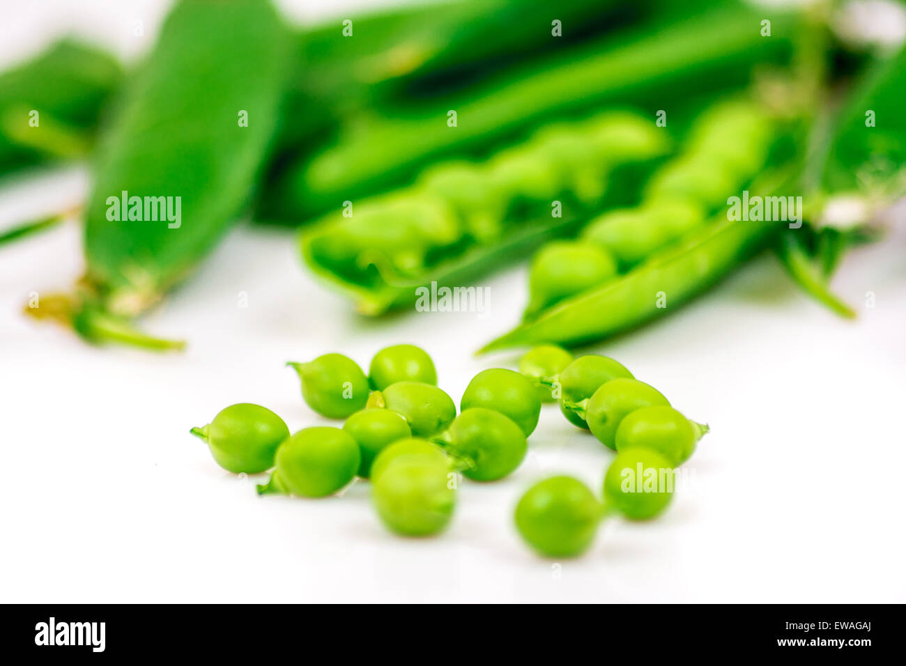 Many raw open pea isolated on white background Stock Photo - Alamy