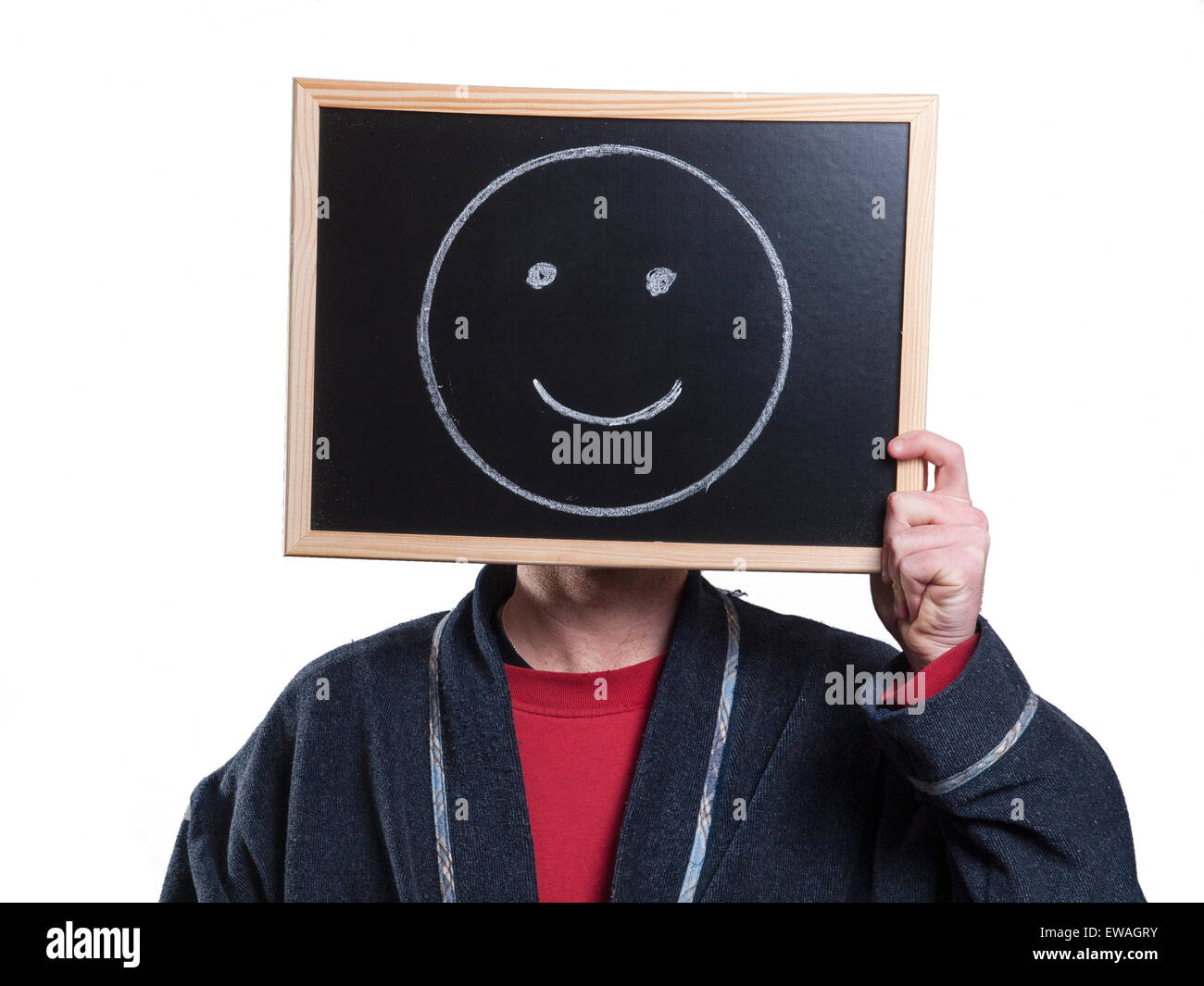 Man hiding his face with a billboard with a smiley face on it Stock ...