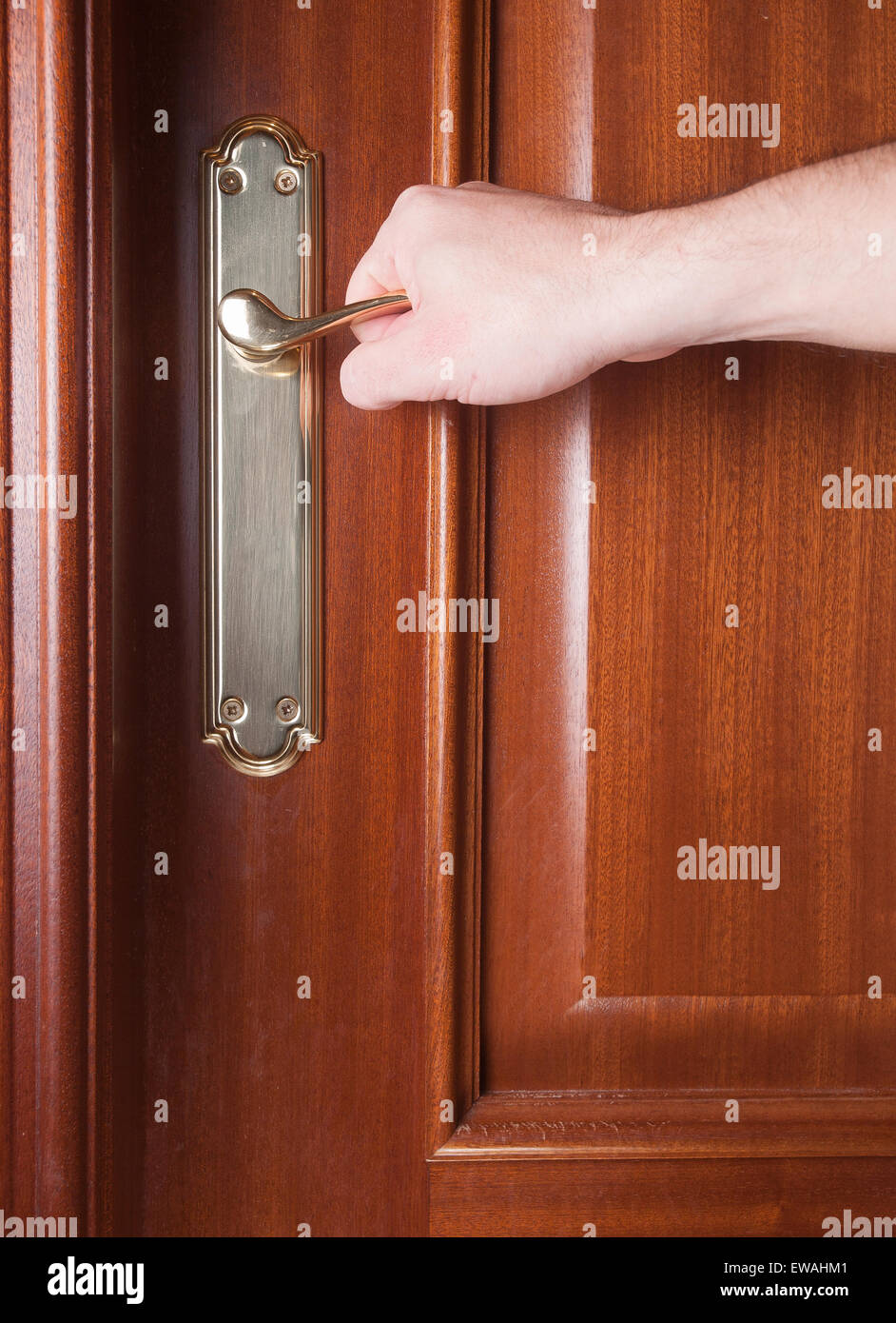 Hand gripping the handle of a door inside home Stock Photo - Alamy