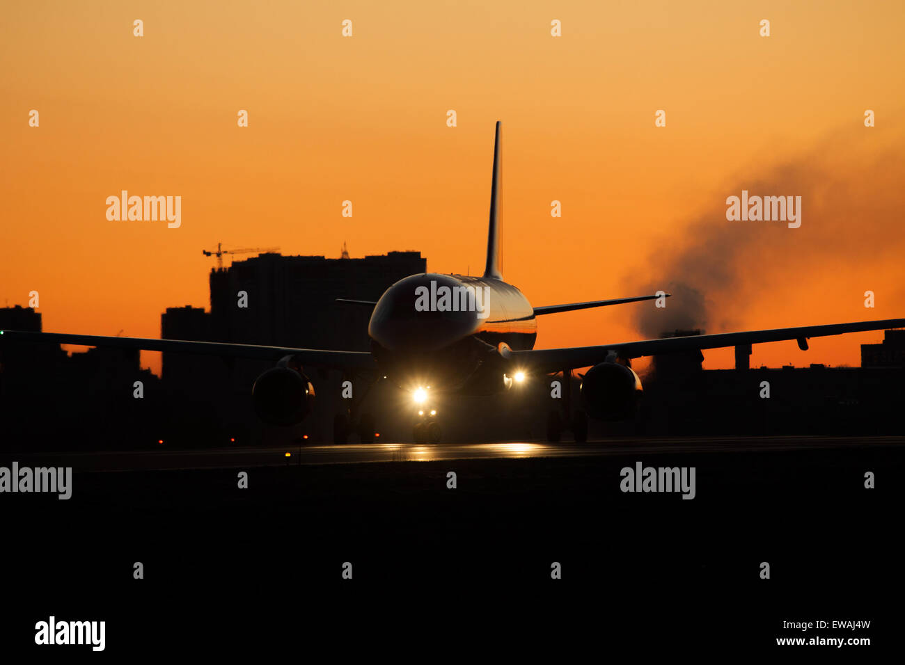 Airplane on airport runway sunset hi-res stock photography and images ...