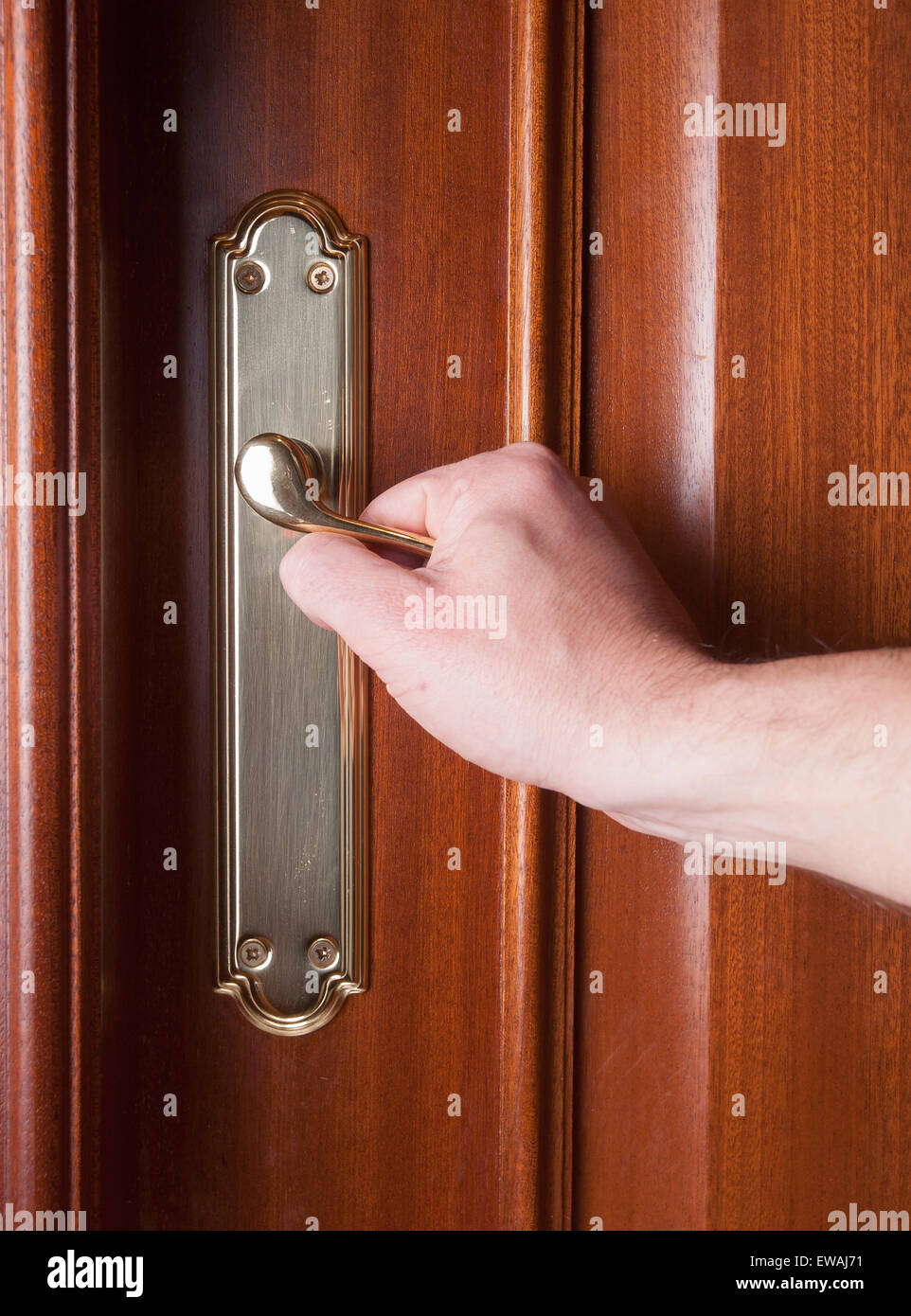Hand gripping the handle of a door inside home Stock Photo - Alamy
