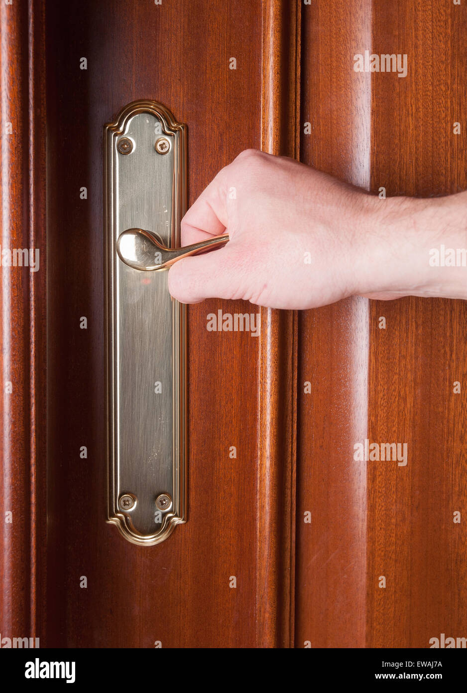 Hand gripping the handle of a door inside home Stock Photo - Alamy