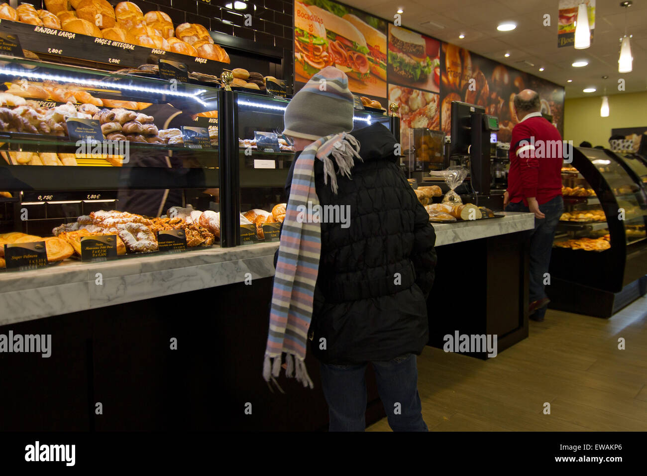 A happy young girl is showing her pastry in a Spanish bakery Stock ...
