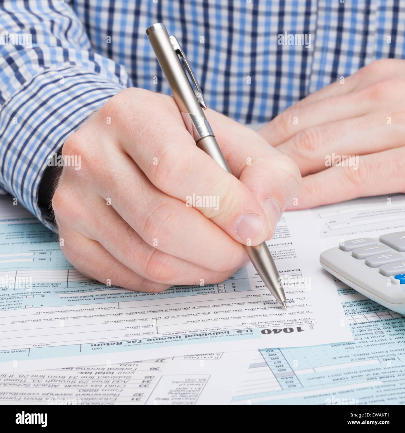 Taxpayer filling out 1040 Tax Form - close up shot Stock Photo - Alamy