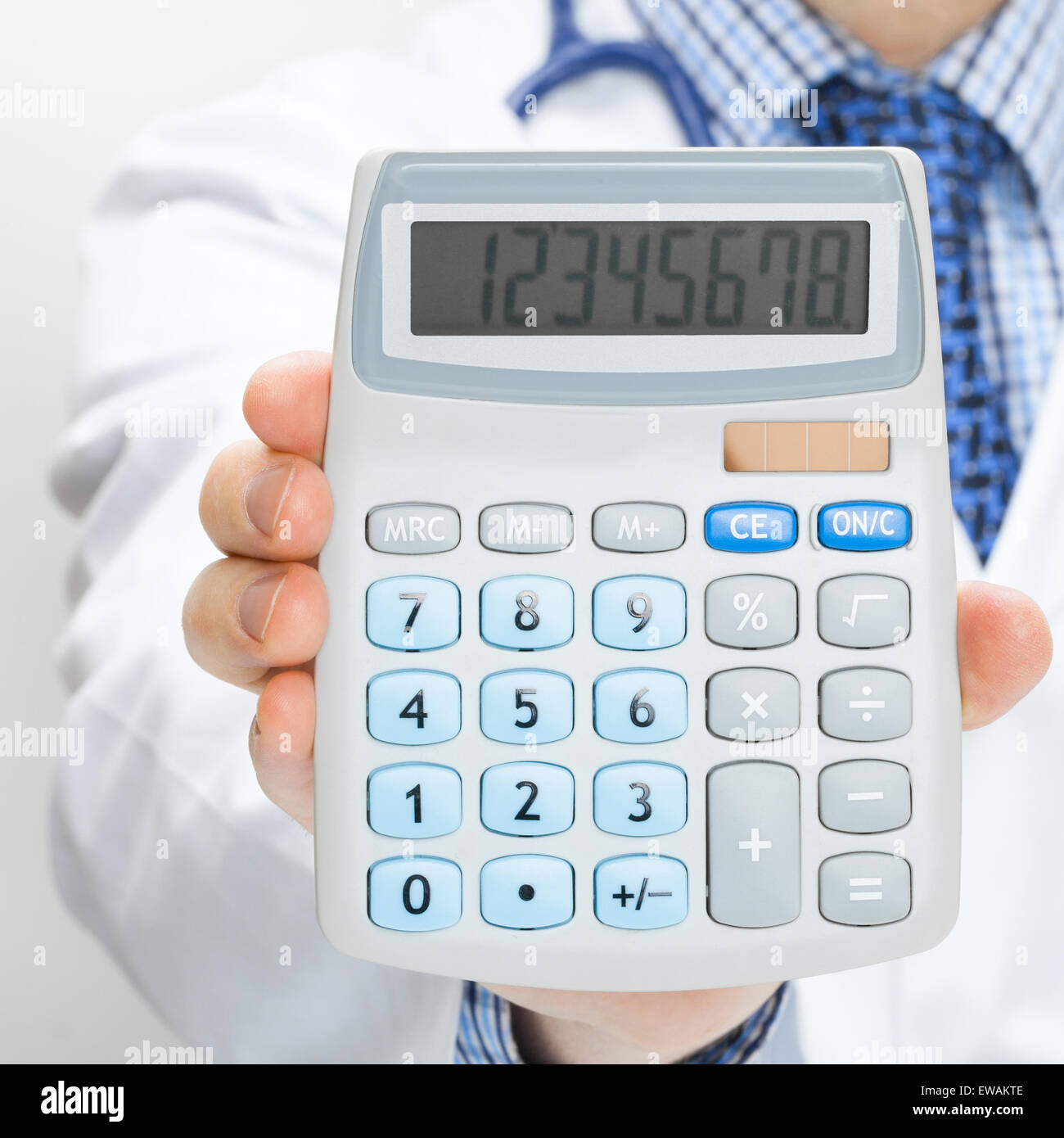 Doctor holding calculator in hand - health care concept - close up shot ...