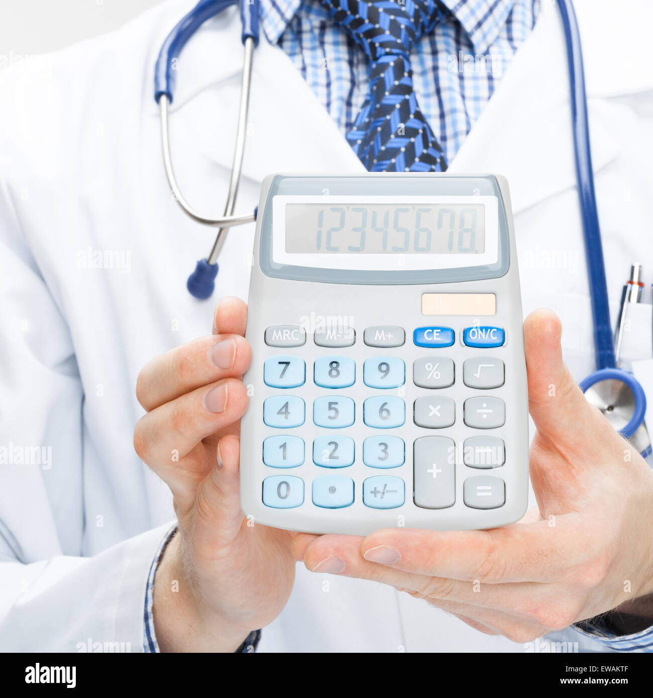 Doctor holding calculator in hands - health care concept - close up ...