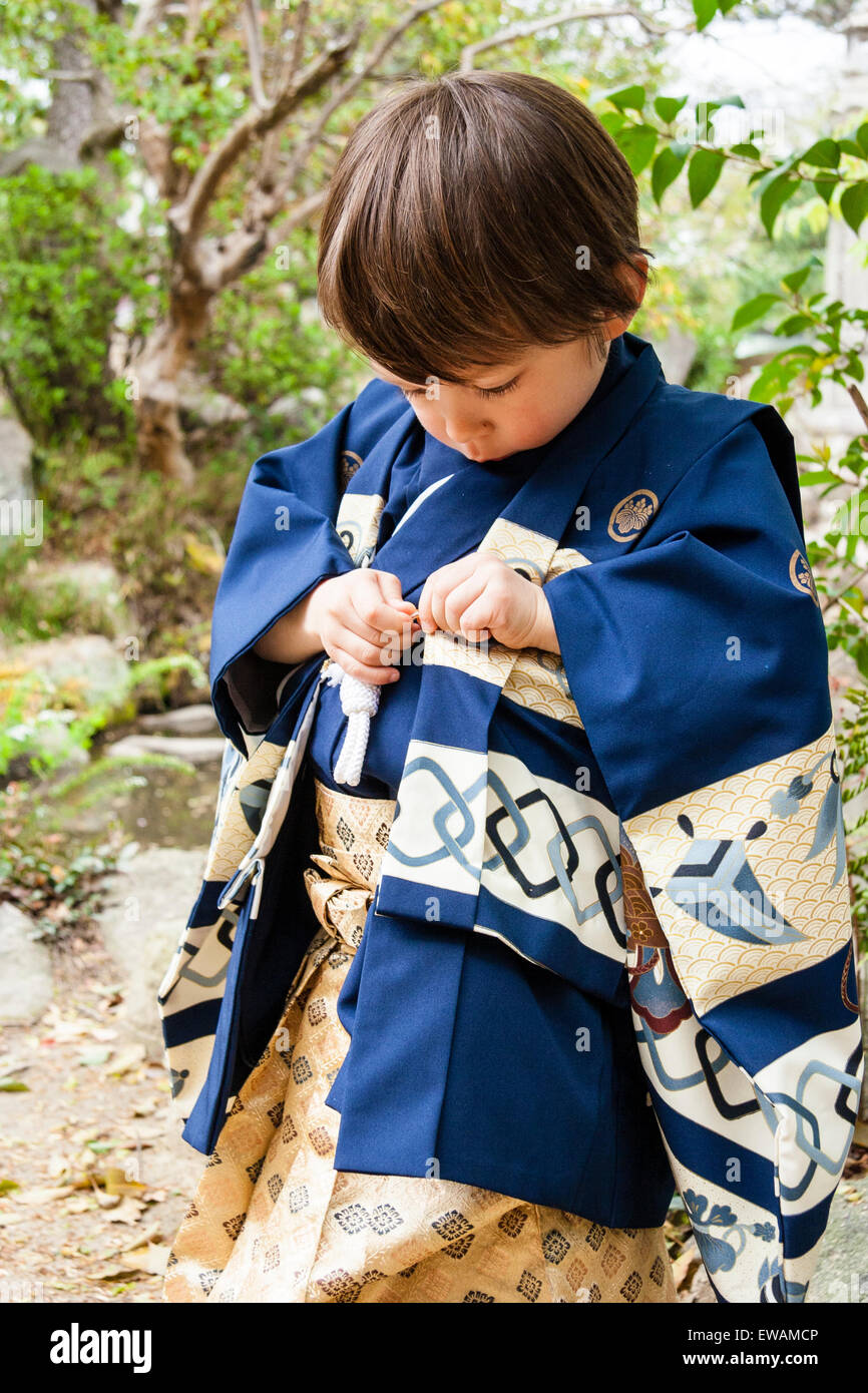 Japanese-English mixed race child, boy, dressed outdoors in blue kimono ...