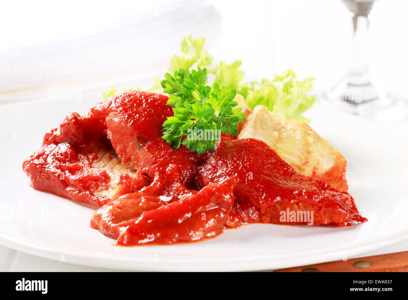 Pan fried fish fillets in rich tomato sauce Stock Photo - Alamy