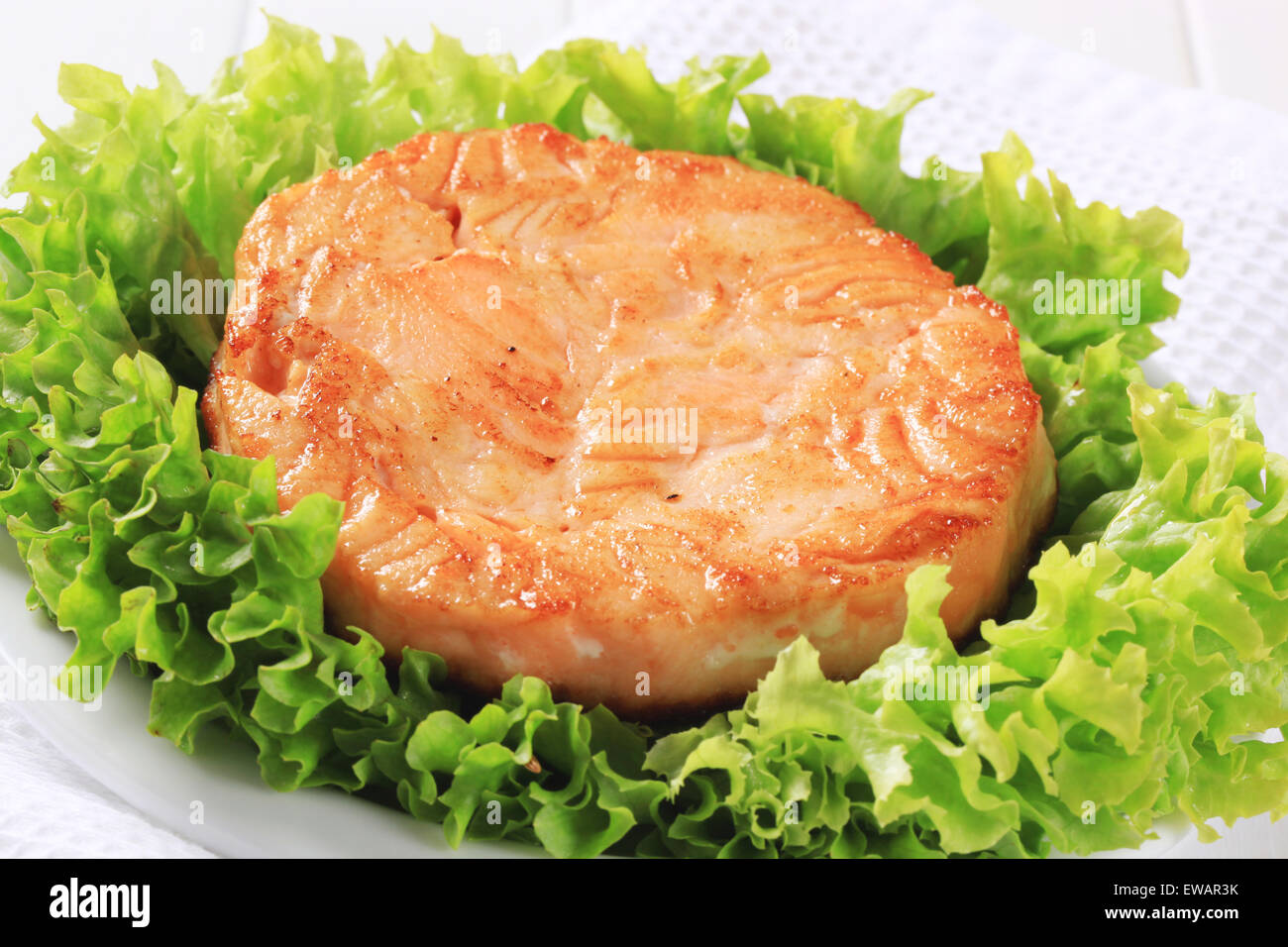 Pan fried salmon patty served on lettuce Stock Photo - Alamy