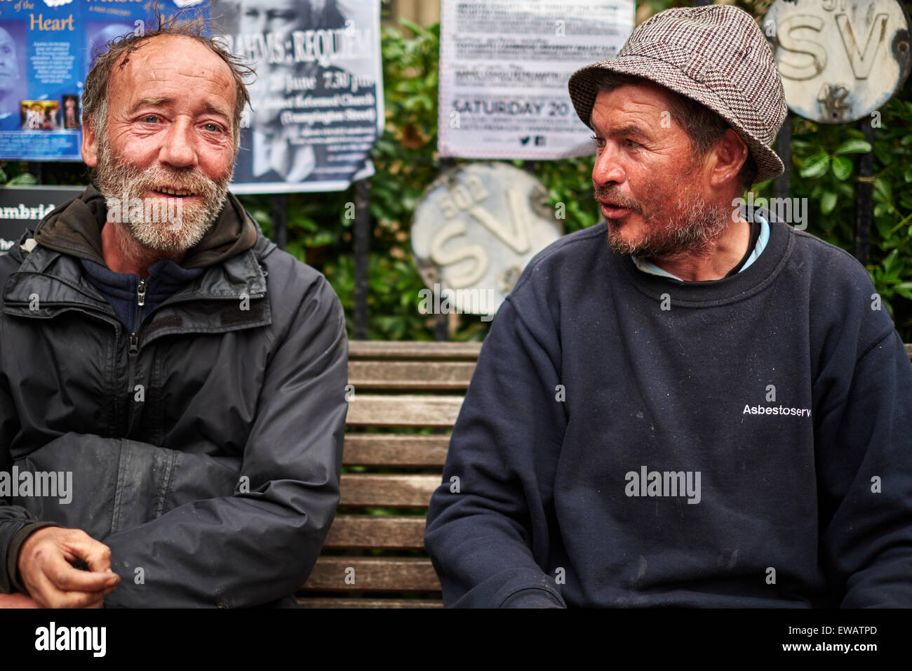 Two homeless men sitting on a bench Stock Photo - Alamy