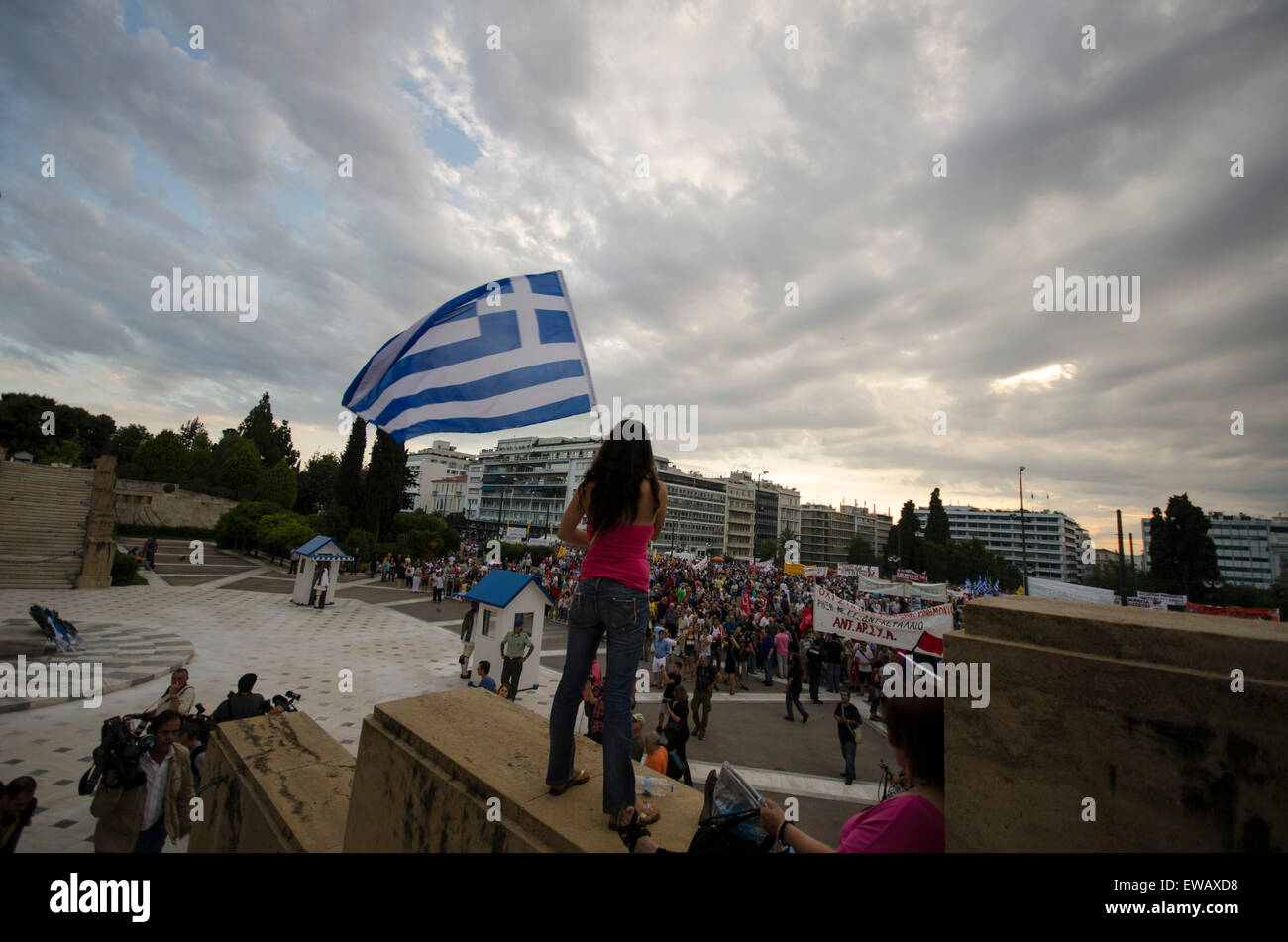 Athens, Greece. 21st June, 2015. A demonstrator waves a huge Greek flag ...
