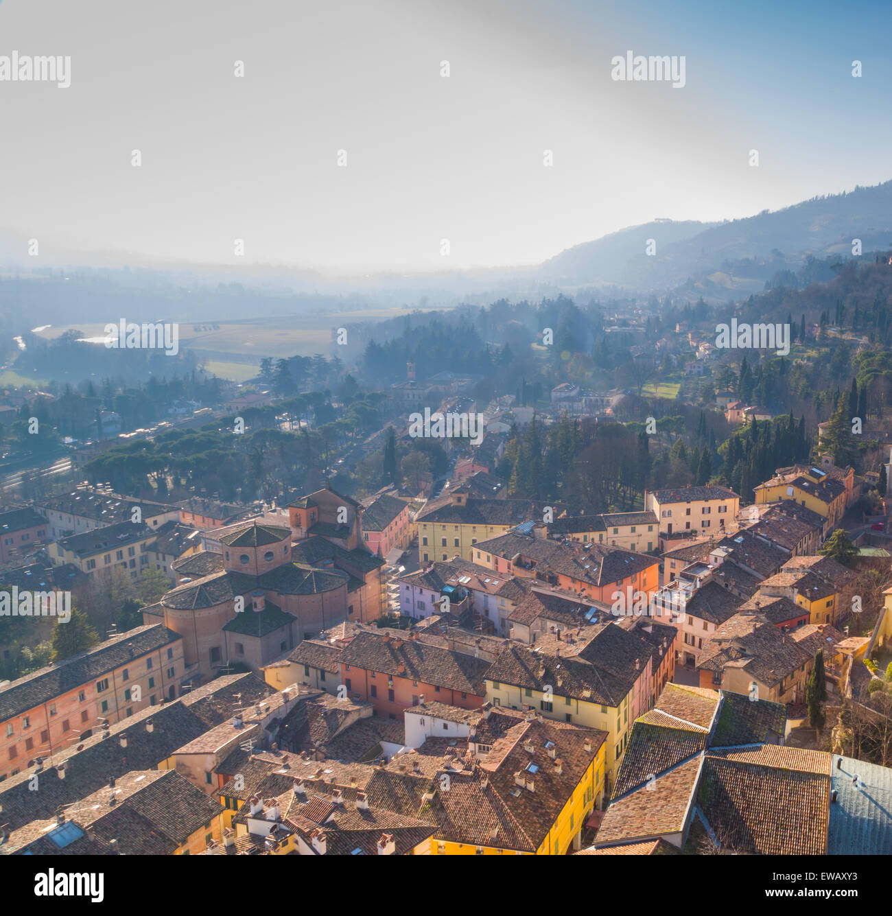 Tile roofs of Italian country village in a winter foggy and sunny day ...