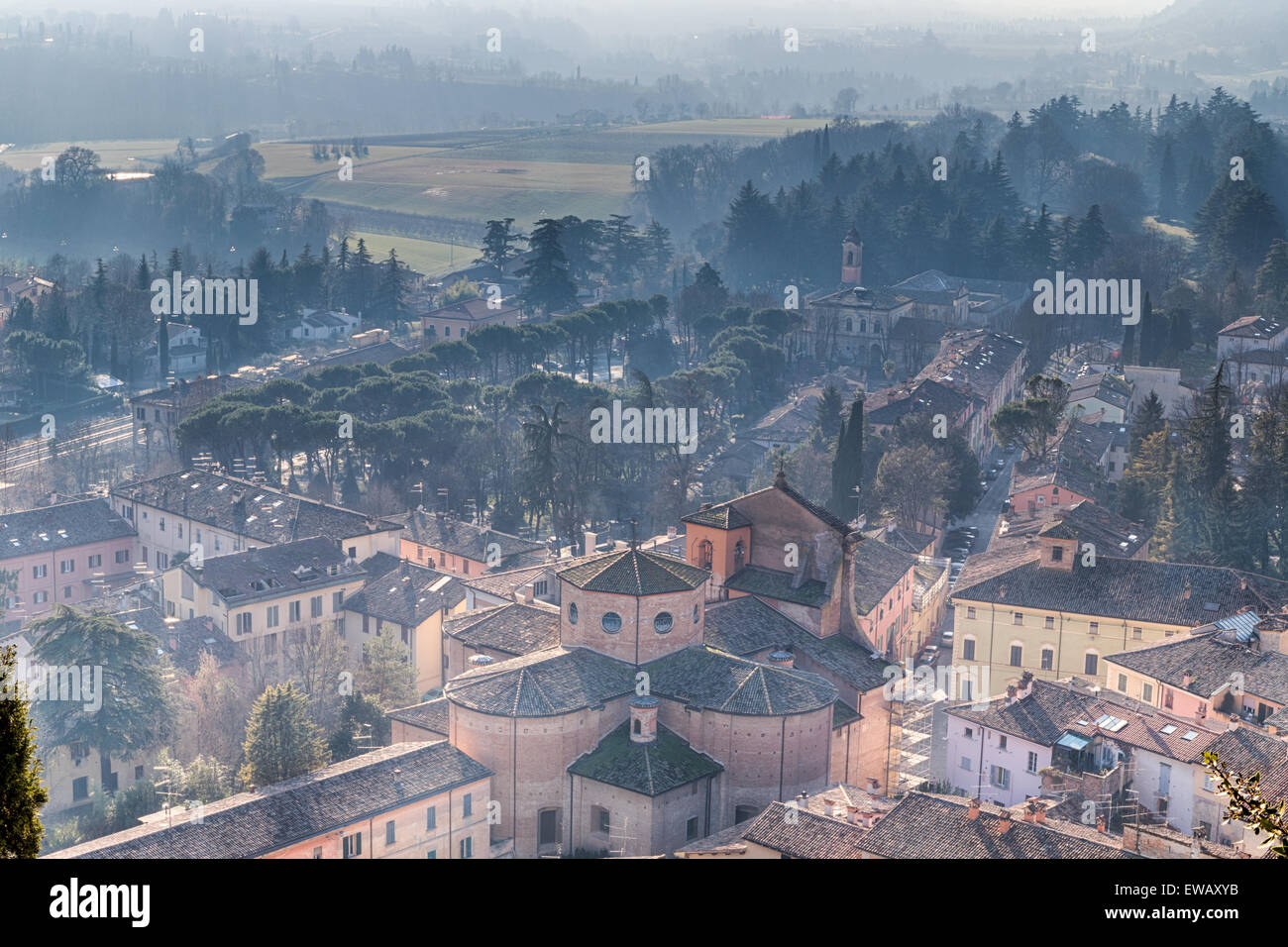 Tile roofs of Italian country village in a winter foggy and sunny day ...