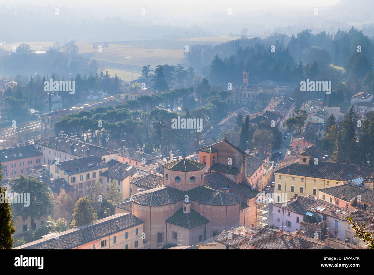 Tile roofs of Italian country village in a winter foggy and sunny day ...