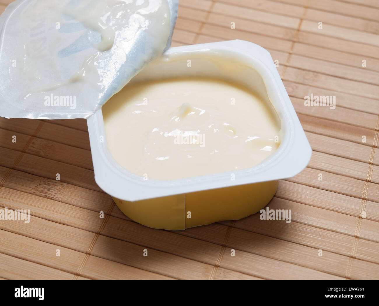 Vanilla custard in a plastic container on bamboo background Stock Photo ...