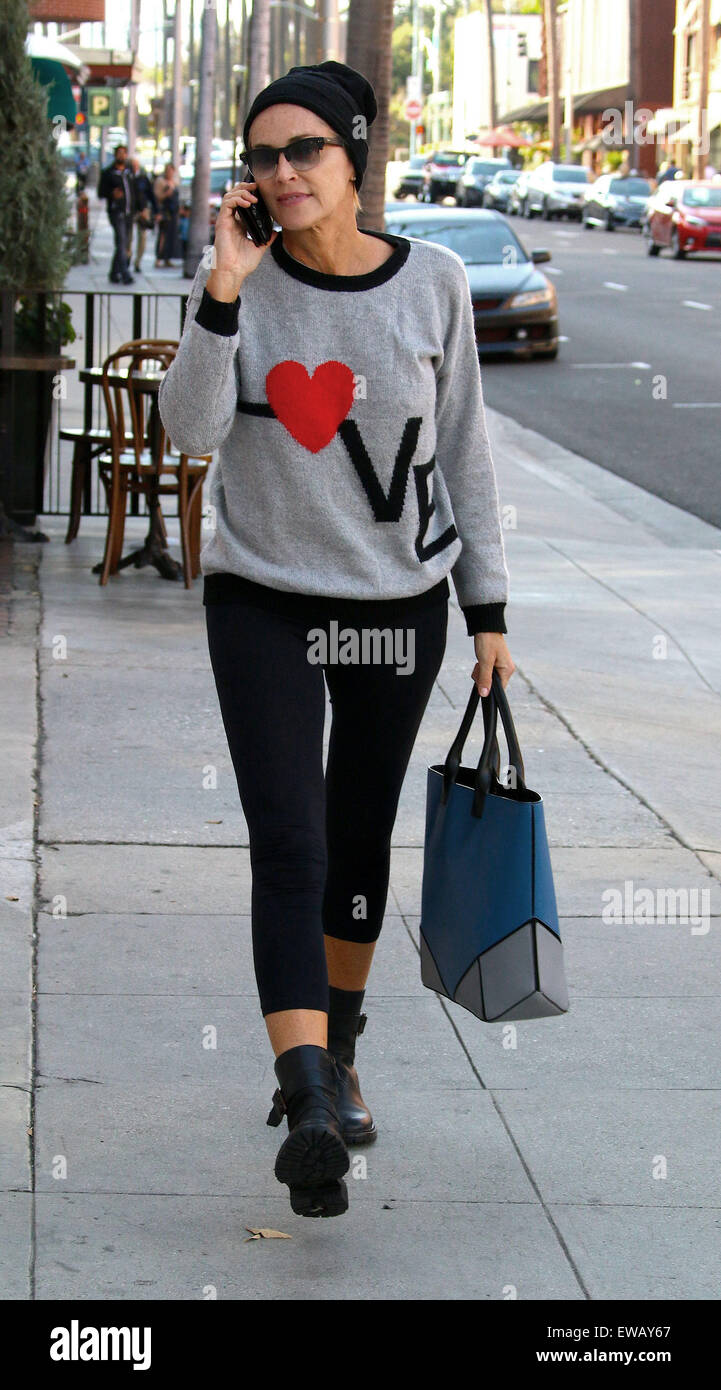 Sharon Stone happily talking on her cellphone as she goes out and about ...