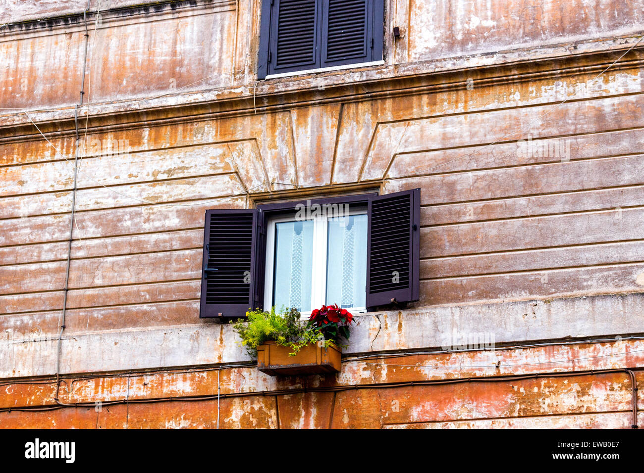 Window of historical building in the center of Rome with flowers Stock ...