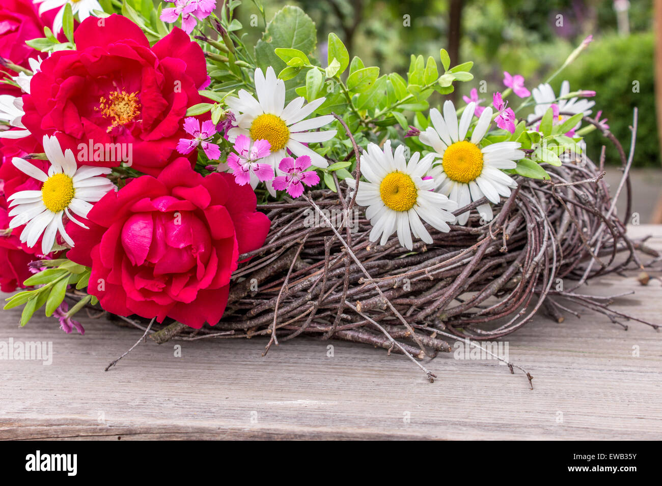 Wreath with red roses and daisies Stock Photo - Alamy