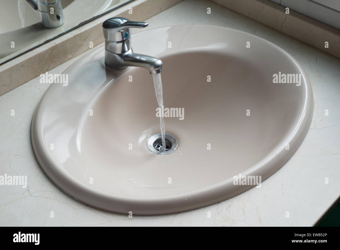 working water tap in a bathroom. Bathroom detail Stock Photo - Alamy
