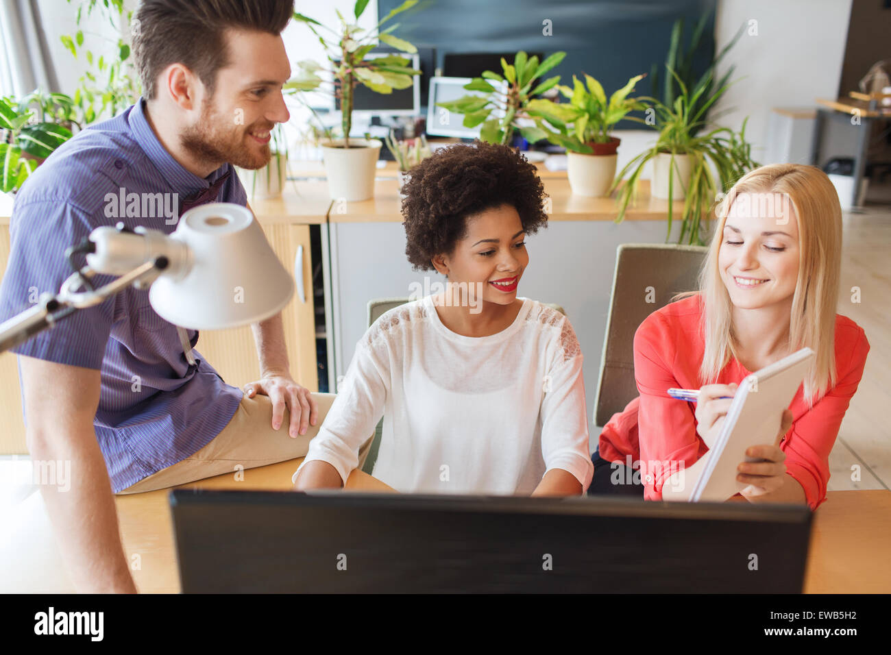 happy creative team with computer in office Stock Photo - Alamy