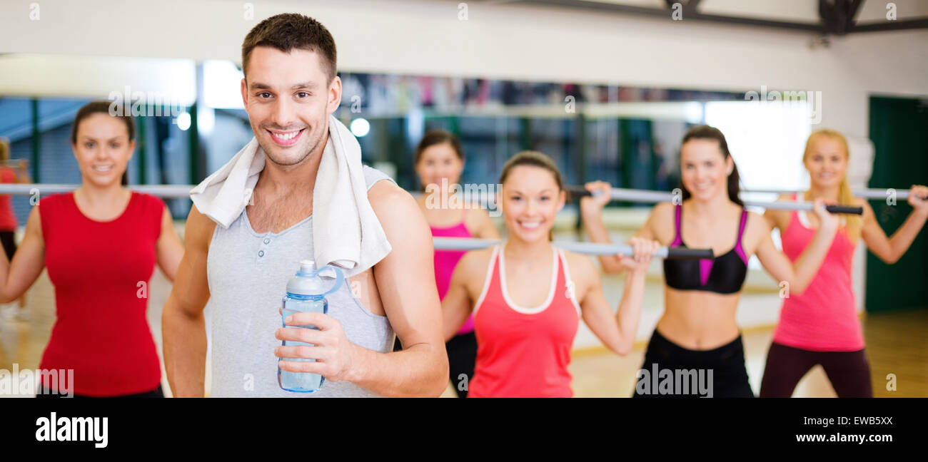 smiling trainer in front of group of people Stock Photo - Alamy