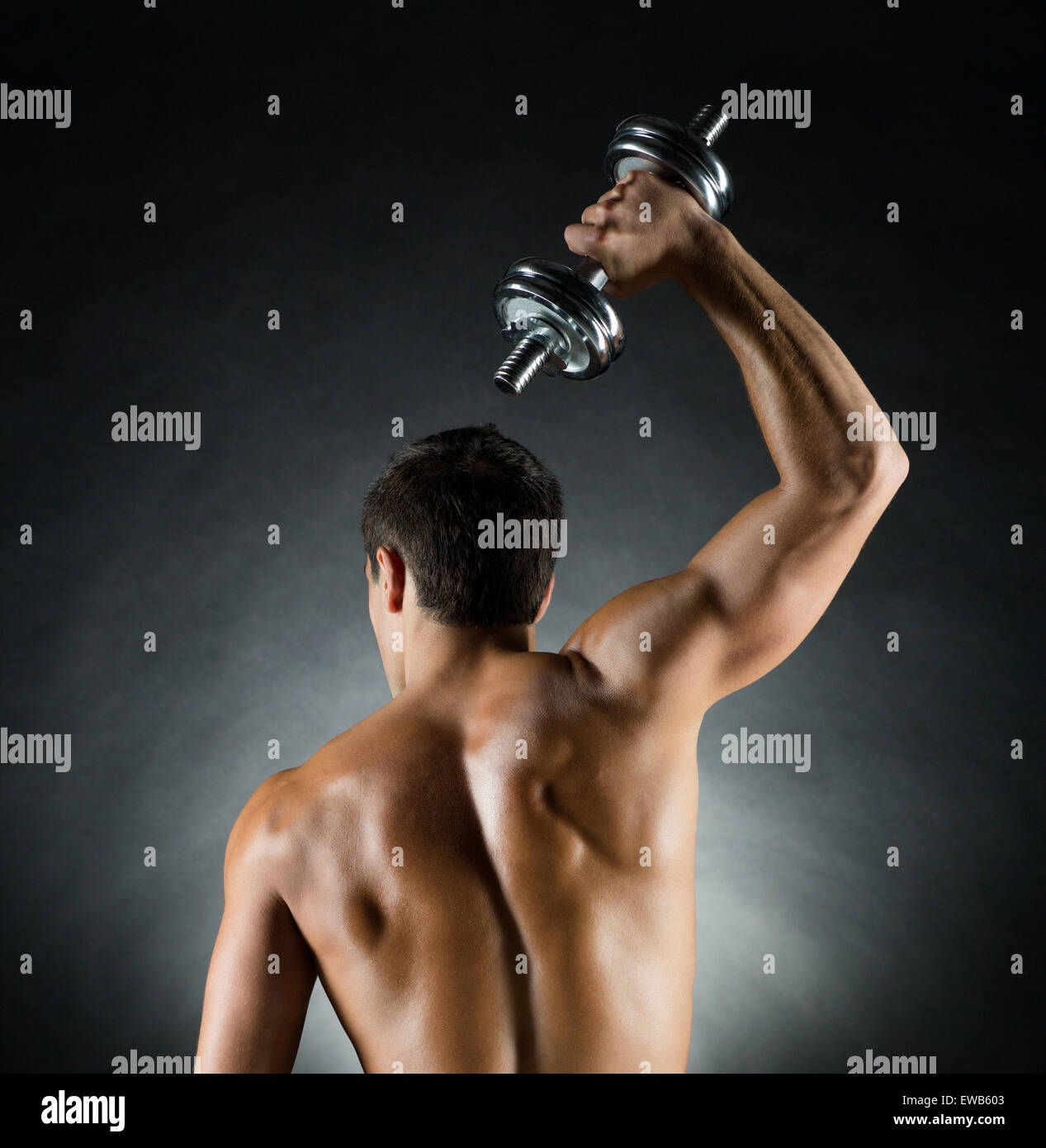 young man with dumbbell Stock Photo - Alamy