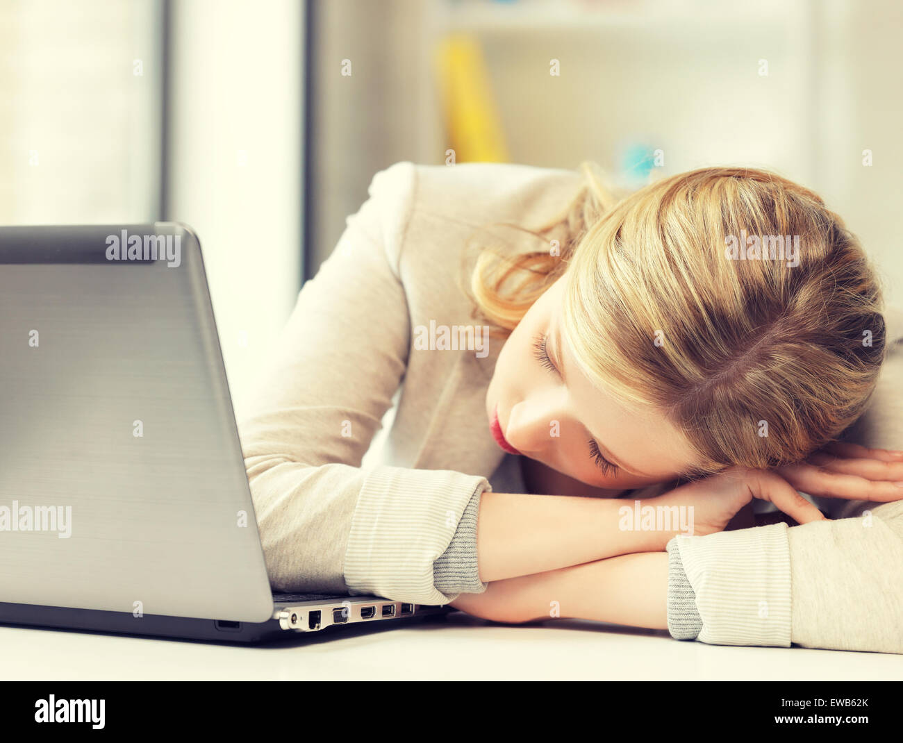 bored and tired woman sleeping on the table Stock Photo - Alamy