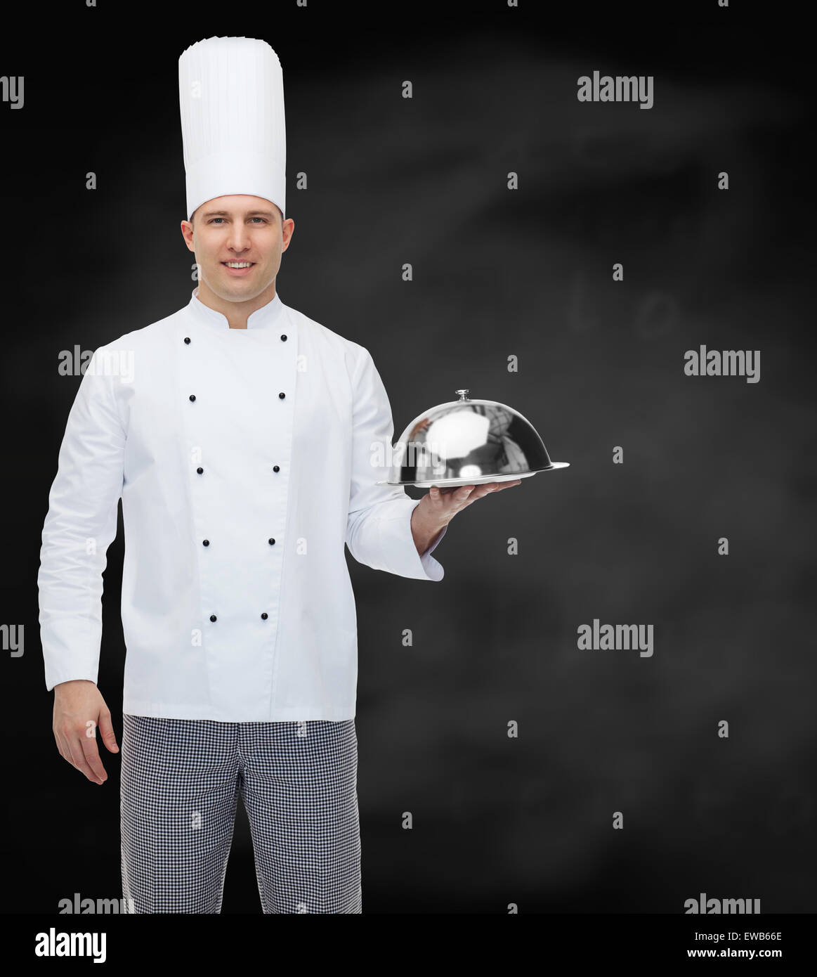 happy male chef cook holding cloche Stock Photo - Alamy