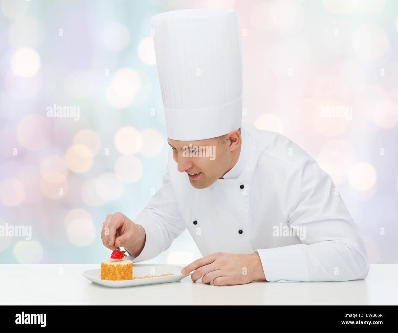 happy male chef cook decorating dessert Stock Photo - Alamy