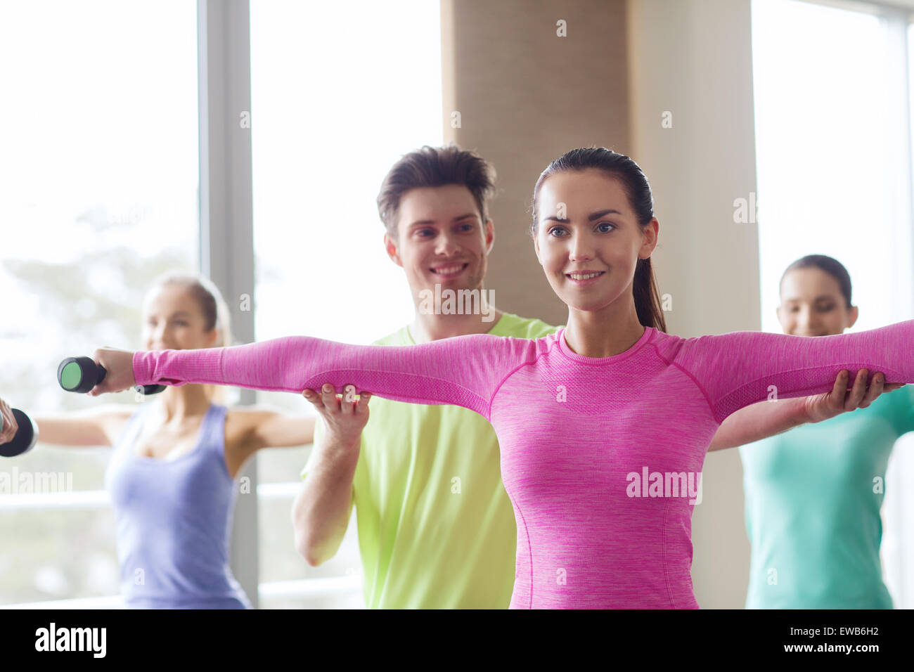 group of smiling people working out with dumbbells Stock Photo - Alamy