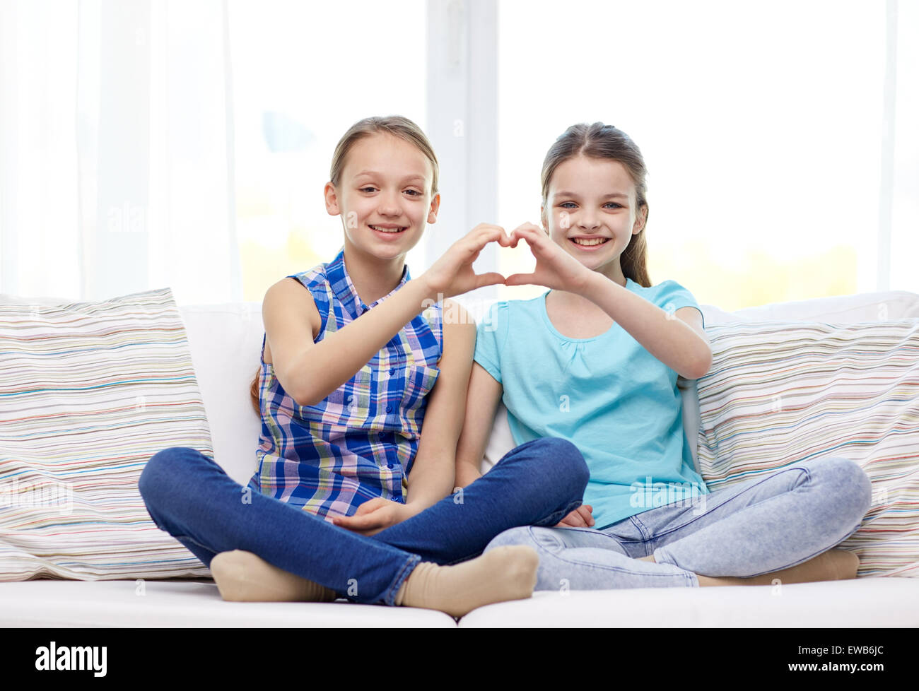 happy little girls showing heart shape hand sign Stock Photo - Alamy