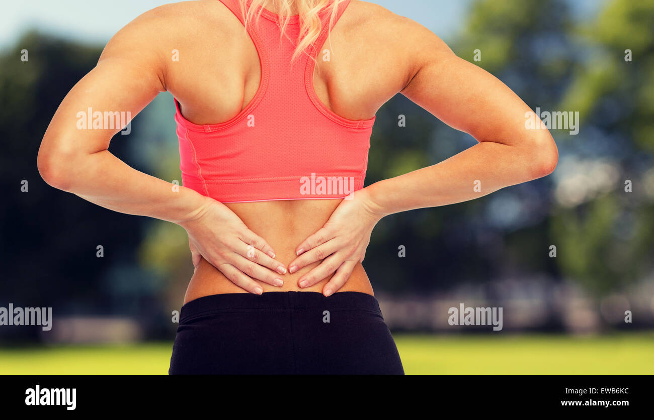 close up of sporty woman touching her back Stock Photo - Alamy