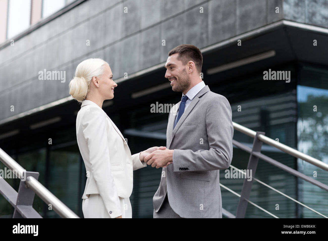 Smiling man shaking hands colleagues hi-res stock photography and ...