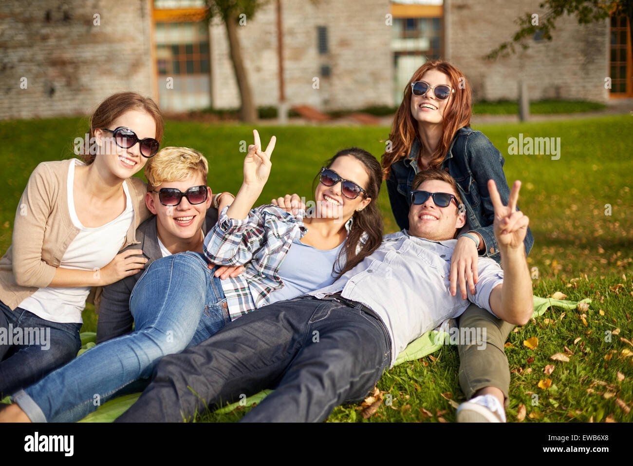 group of happy students showing victory gesture Stock Photo - Alamy