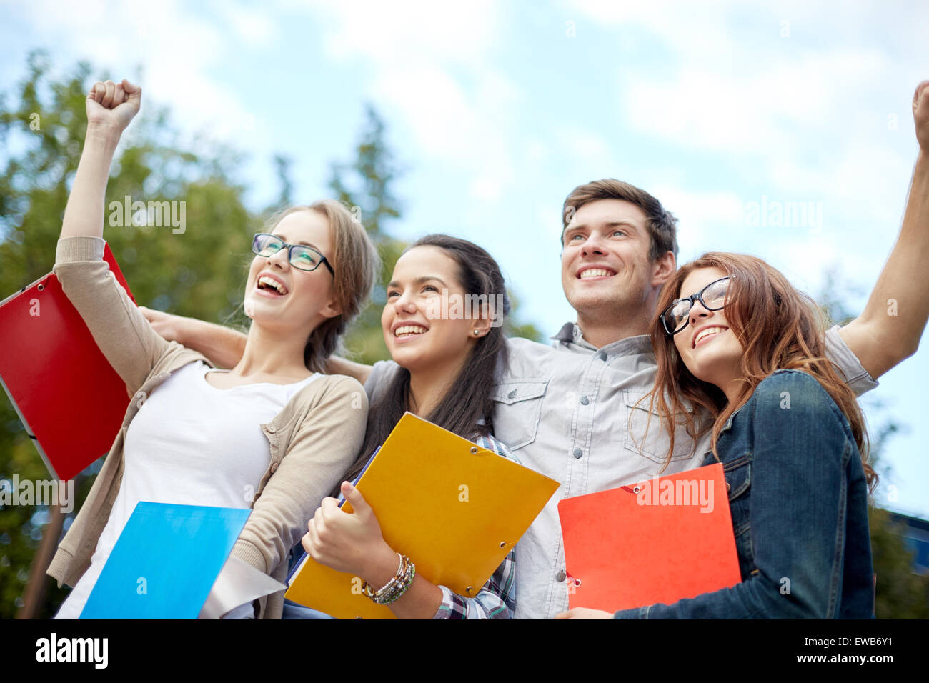 group of happy students showing triumph gesture Stock Photo - Alamy