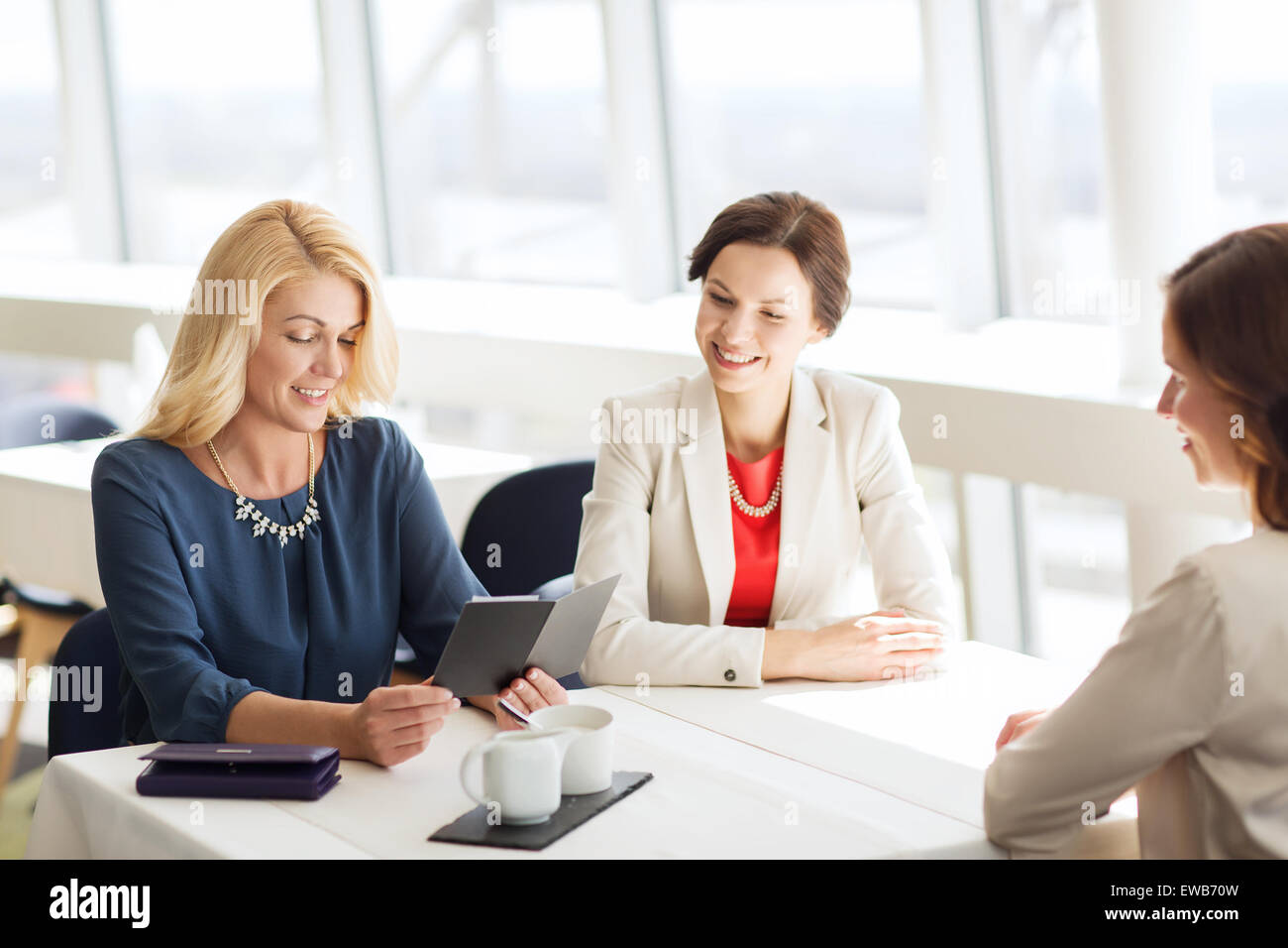 Happy women looking restaurant bill hi-res stock photography and images ...