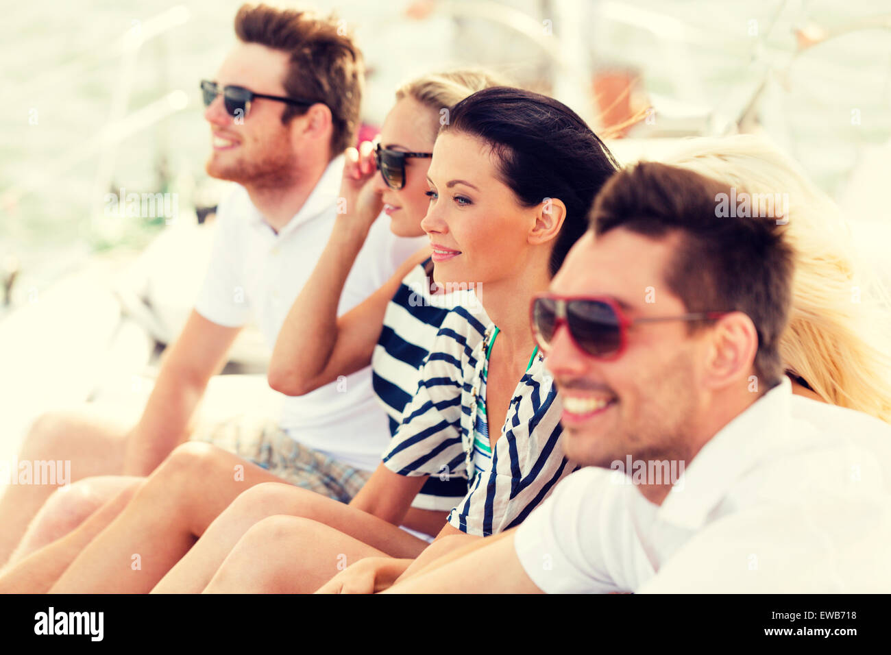 smiling friends sitting on yacht deck Stock Photo - Alamy