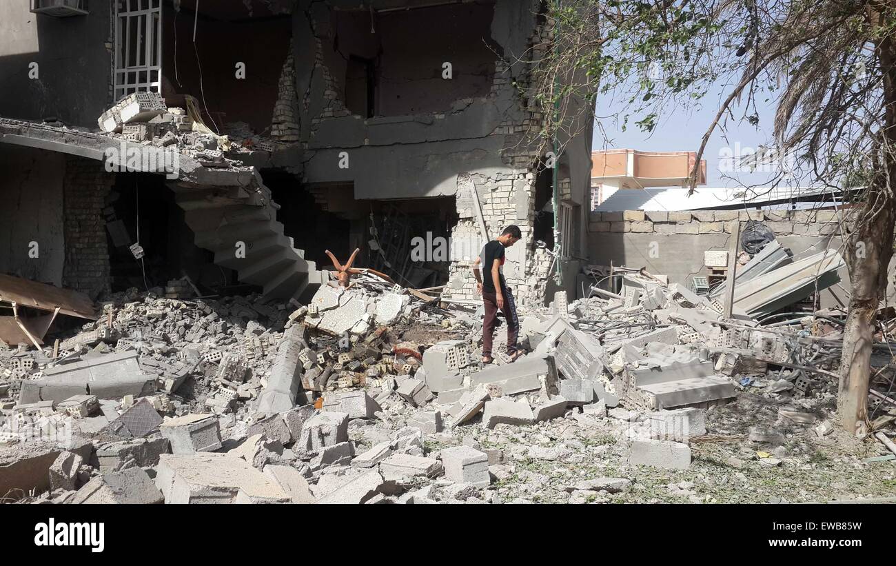 Fallujah, Iraq. 22nd June, 2015. A man inspects a destroyed building ...