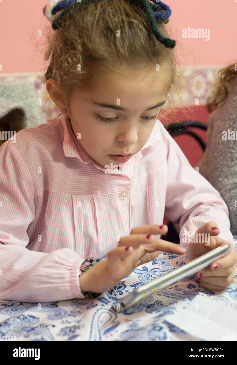 Little girl using an smartphone at school Stock Photo - Alamy