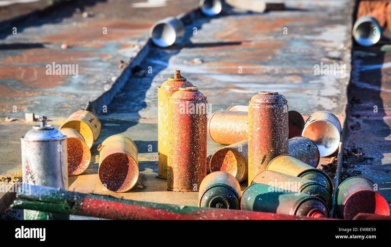 Used graffiti spray cans laying around Stock Photo - Alamy