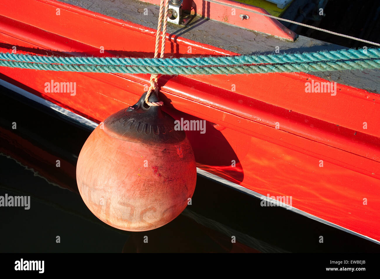 Boat with buoy, painted red Stock Photo - Alamy