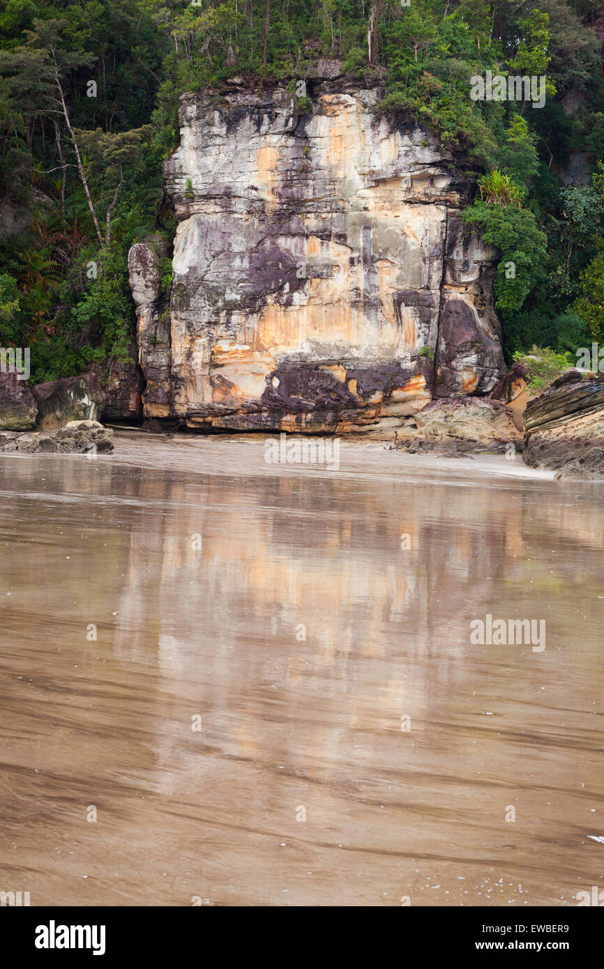 Big rock reflection from wet sand Stock Photo - Alamy