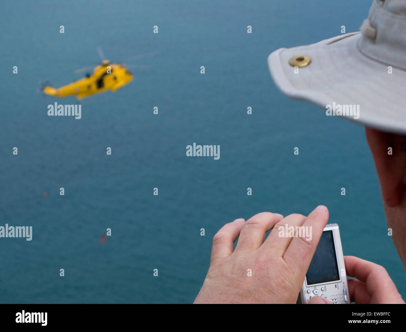 Man walker photographing rescue helicopter Stock Photo - Alamy