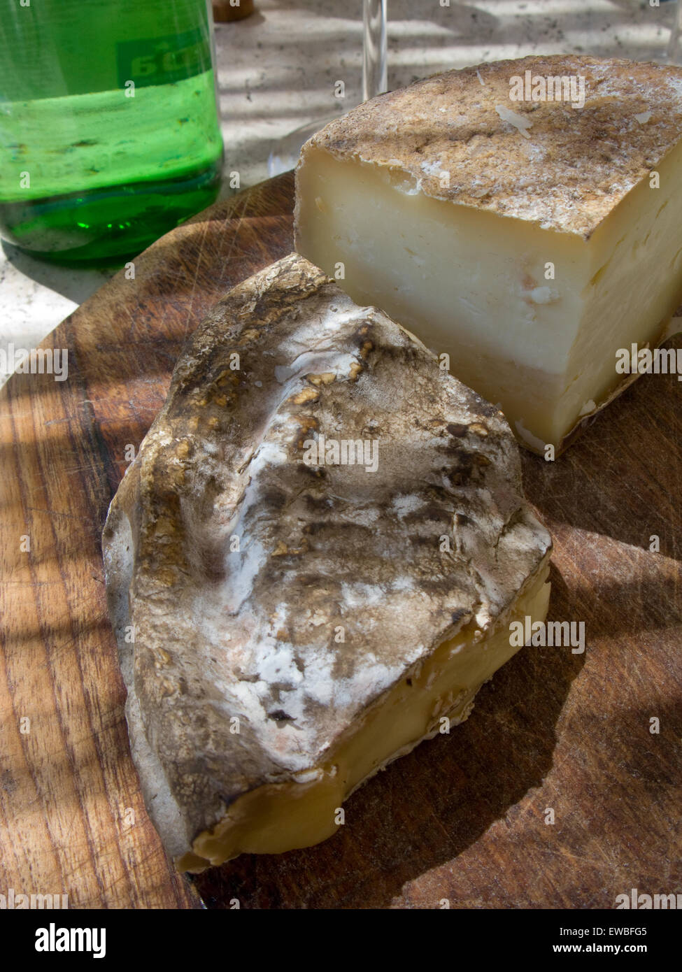 Rustic cheeses ready for lunch on table Stock Photo - Alamy